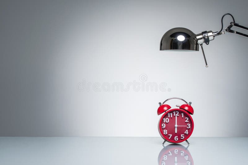 Lighting Up Red Alarm Clock with Desk Lamp Stock Photo - Image of angle ...