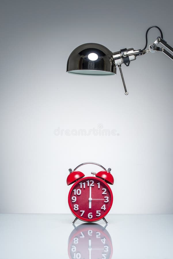 Lighting Up Red Alarm Clock with Desk Lamp Stock Photo - Image of ...