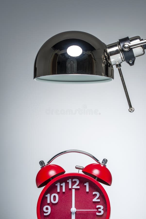 Lighting Up Red Alarm Clock with Desk Lamp Stock Photo - Image of poise ...
