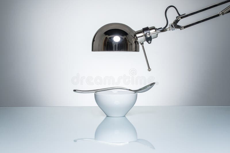 Lighting Up White Ceramic Bowl Silver Spoon with Desk Lamp Stock Photo ...