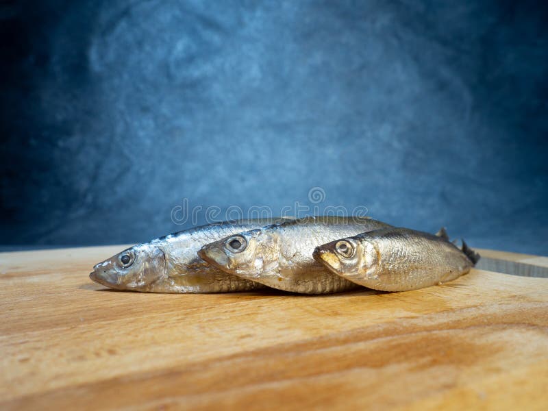 Lightly Salted Sprat on a Cutting Board. Whole Small Fish on the Table ...