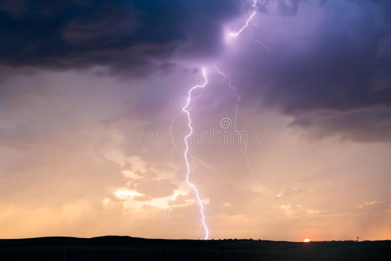 Lightning Bolt Strike in a Storm at Sunset Stock Photo - Image of ...