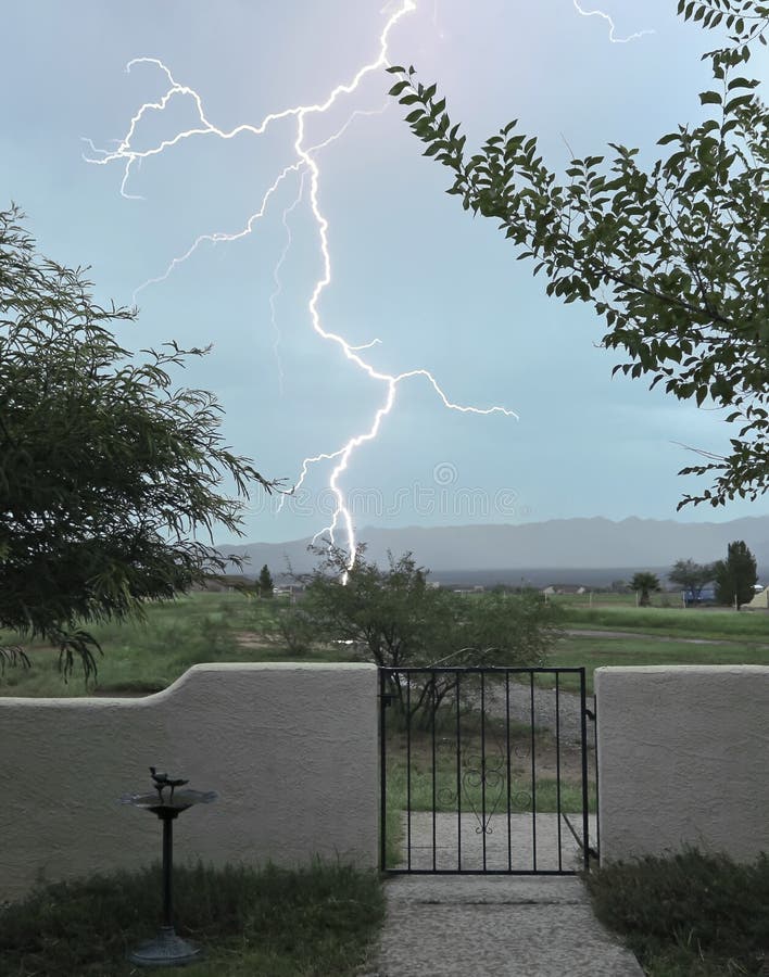 A Lightning Bolt Strikes Outside the Gate Stock Image - Image of ground ...
