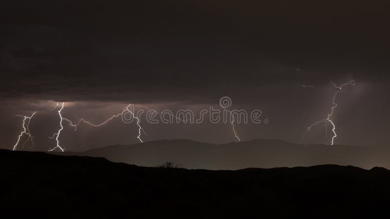 Lightning Flickering Over Distant Mountains at Night Stock Photo - Image of electric, light ...