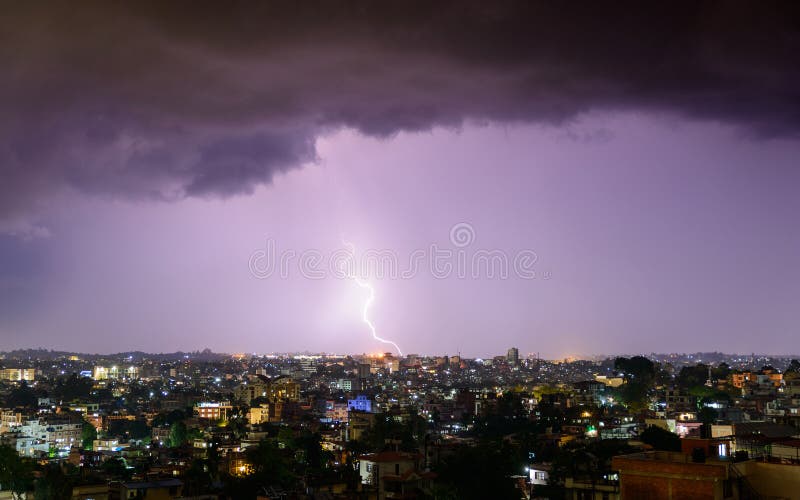 A Lightning Hitting the Ground during a Thunderstorm in Nighttime Stock ...