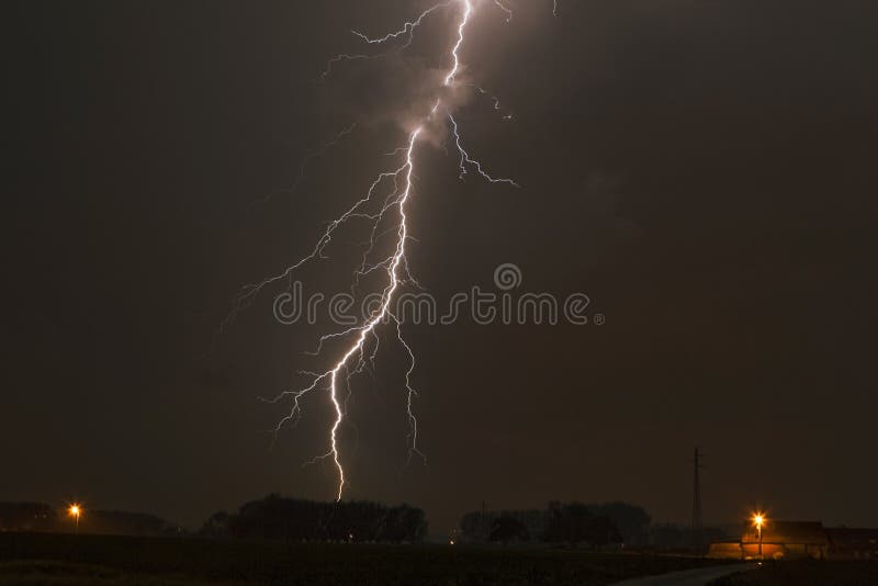 Lightning in a Slow Moving Thunderstorm Over Trees. Stock Photo - Image ...