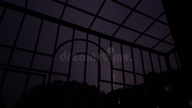 Lightning in a Night Sky Behind the Glass Window Structure Stock Photo ...