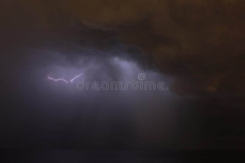 Lightning Piercing the Clouds in the Darkness of the Storm Stock Photo ...
