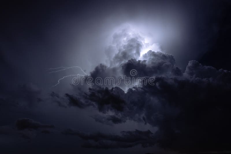 Lightning Radiates through the Clouds at Night Stock Image - Image of ...