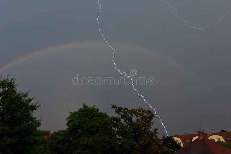 Lightning and rainbow stock photo. Image of colors, city - 27720426