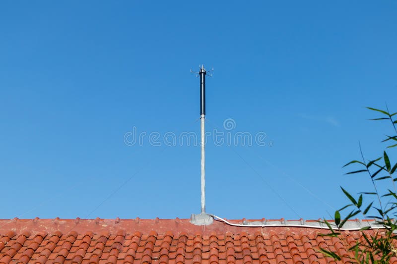 Lightning Rod on the Tile Roof of a Building with Blue Sky Background ...