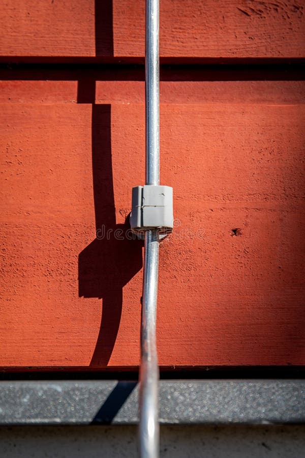 Lightning Rod on the Wall of a Red Wooden Building. Architecture and ...