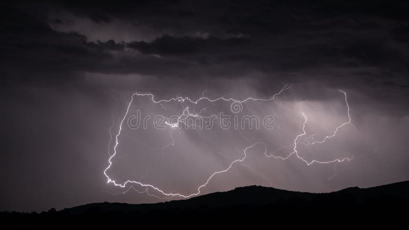 Lightning Strike Over Mountain Range Stock Photo - Image of flare ...