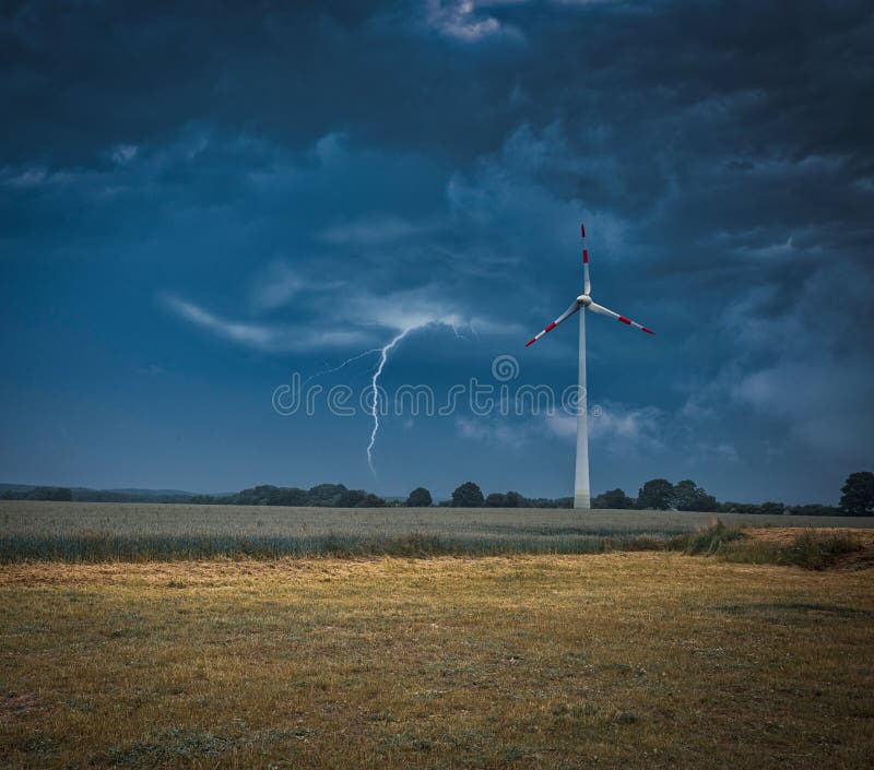A Lightning Strikes the Ground Next To a Wind Turbine Stock Photo ...
