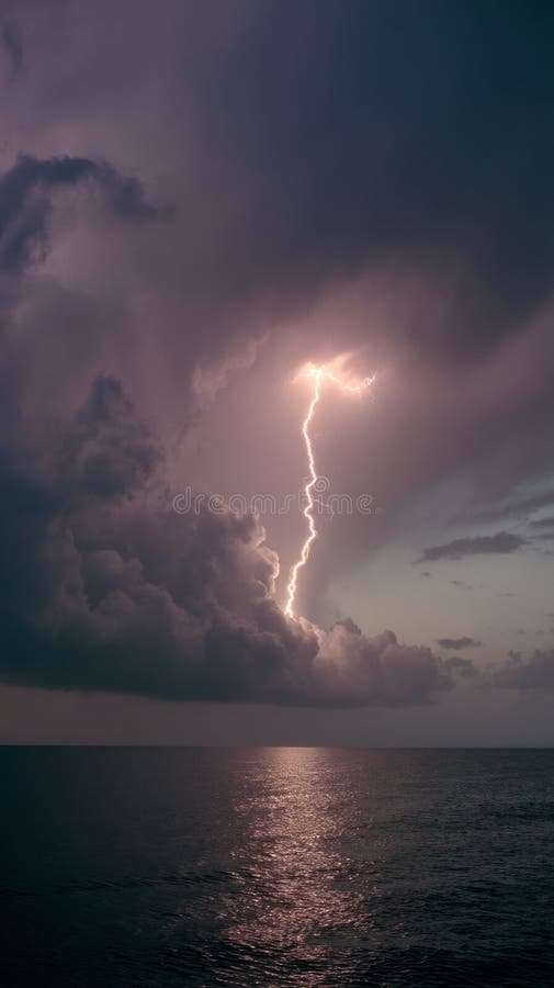 Lightning Strikes Over the Ocean As Storm Clouds Gather during Twilight ...