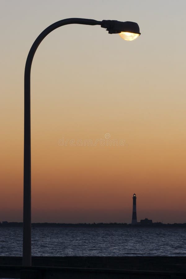 The Lightpost and the Lighthouse Stock Image - Image of sunrise, framed ...