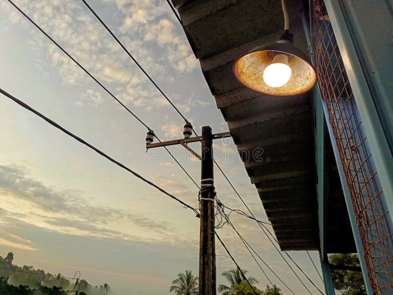 Lights Glow in the Twilight Next To Electricity Poles Stock Image ...