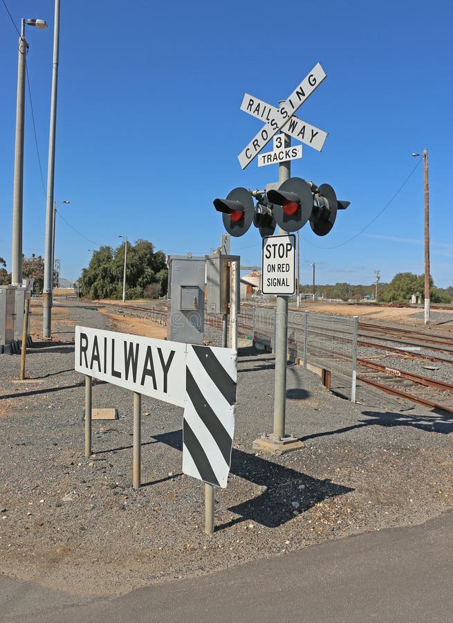 Lights and Signs at a Three-line Railway Crossing Stock Image - Image ...
