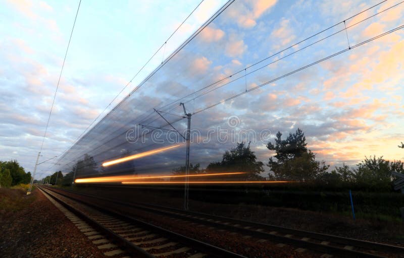 The Lights of a Speeding Train Crossing the Railroad Tracks Stock Photo ...