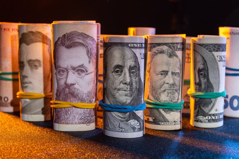 Lights of Various Currencies. Money Rolled on the Table Stock Image ...
