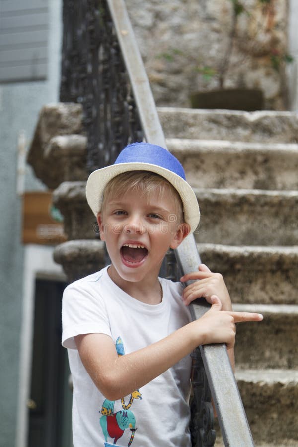 Liitle Kid in a Blue Hat, Standing on the Stairs of the Ancient Stock ...