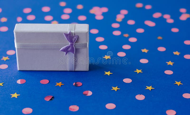 Purple Gift Box on Blue Background with Confetti. Stock Image - Image ...
