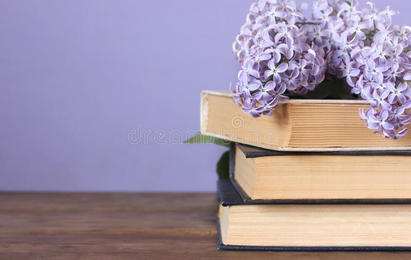 Lilac and a Stack of Books on the Table. Copy Space Stock Image - Image ...