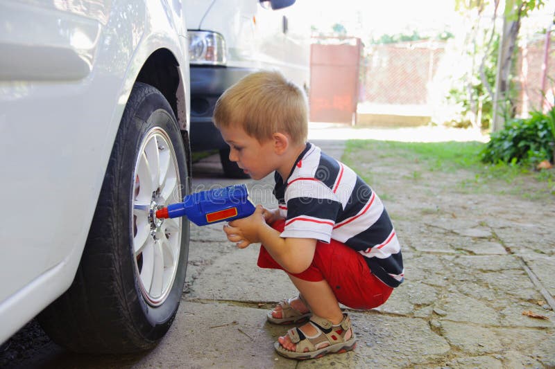 Lillte Child Playing in Auto Mechanic Stock Photo - Image of hand, male ...