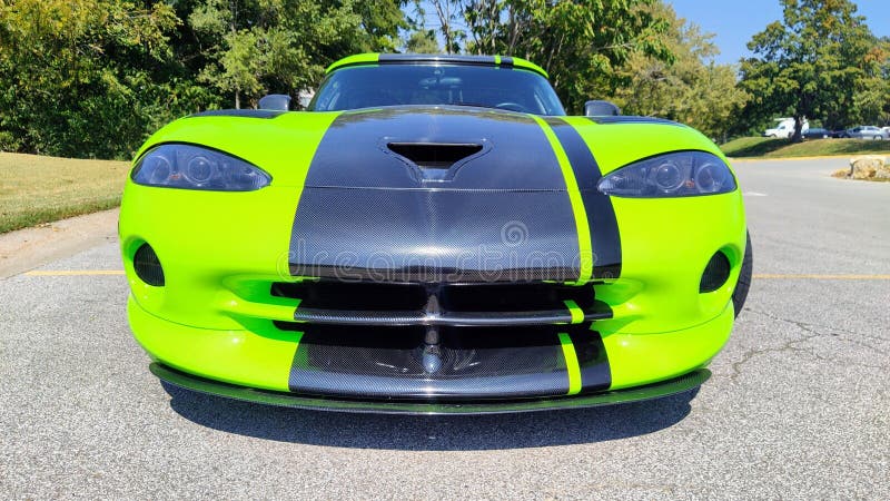 An Lime Colored Viper Car Sits On The Road As A Woman Walks By Stock Image Image Of Stroll