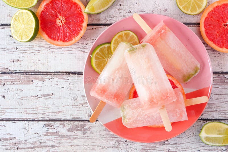 Lime and Grapefruit Ice Pops, Top View Table Scene Over White Wood ...