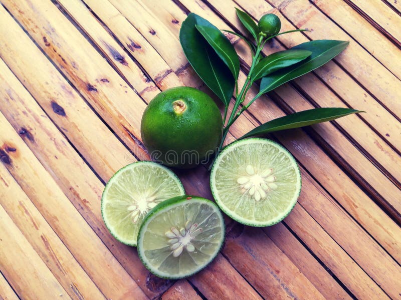 Lime slice on bamboo table stock photo. Image of ingredient - 121693798