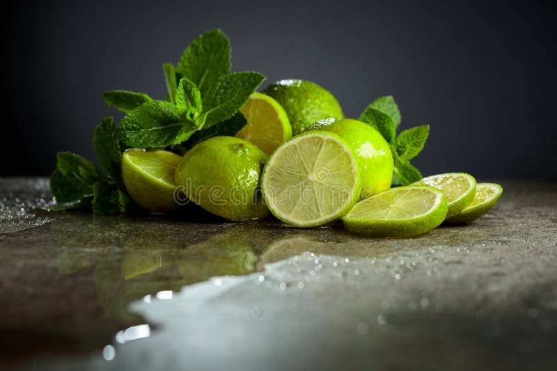 Lime Slices and Fresh Mint Branches on a Stone Table Stock Image ...