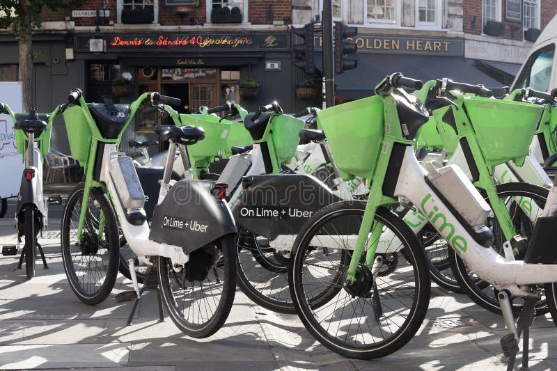 Lime and Uber Electric Bikes for Rent Editorial Stock Photo - Image of ...