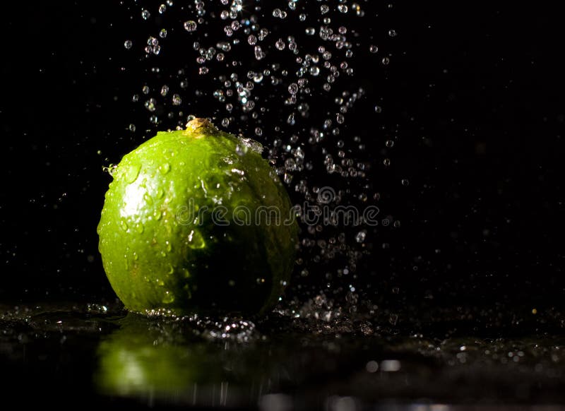 Lime under water jets stock image. Image of splash, piece - 14035303