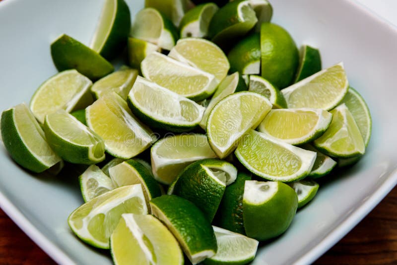 Lime Wedges Lie in a White Plate. Ingredients for a Cocktail Stock ...