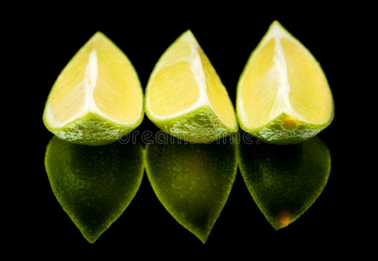 Limes on black mirror stock image. Image of culinary - 53625849