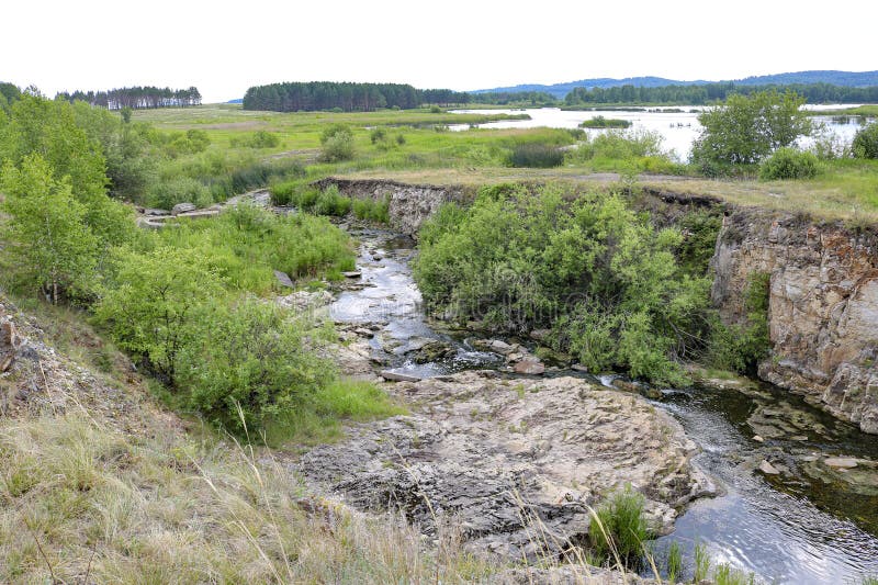 Limestone Cliffs Above a Calm Overgrown River Stock Photo - Image of ...