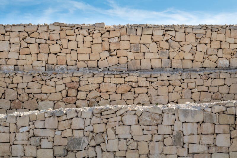 Limestone Layered, Rough Dry Stone Wall, Under a Blue Sky. Stock Photo ...