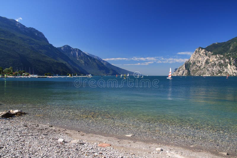 Limpid Waters of Lake Garda in Italy, Surrounded by the Alps Editorial ...