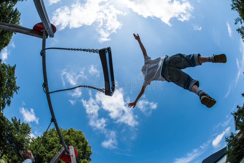 Kid Jumping of a Swing at Summer.. Stock Photo - Image of jumping ...