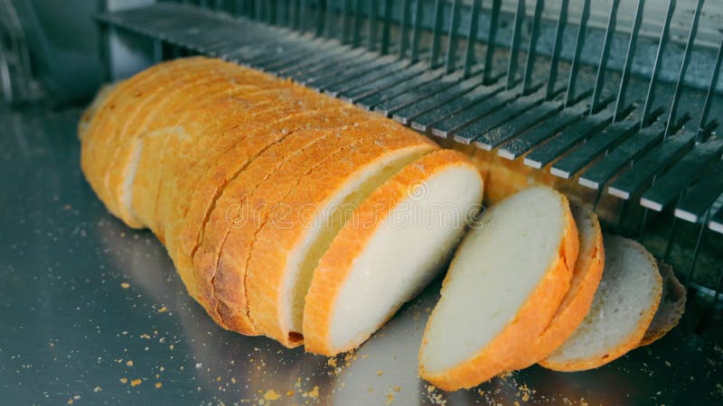 Line of Automatic Bread Cutting. the Machine Cuts Rye Bread before ...