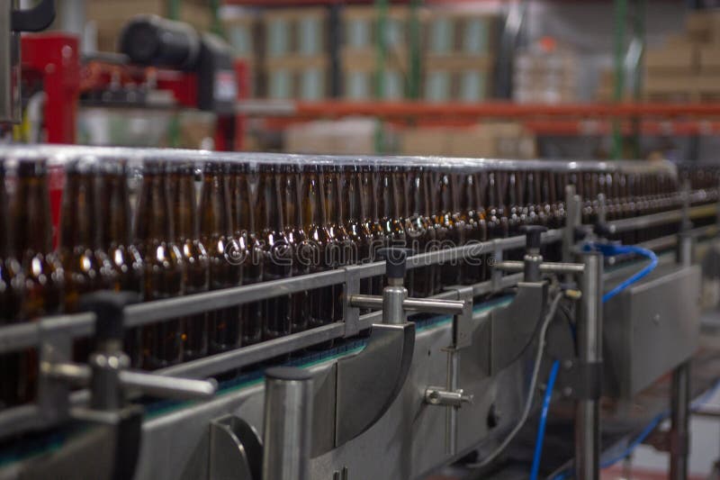 Line of beer bottles stock photo. Image of machine, assembly - 298080864