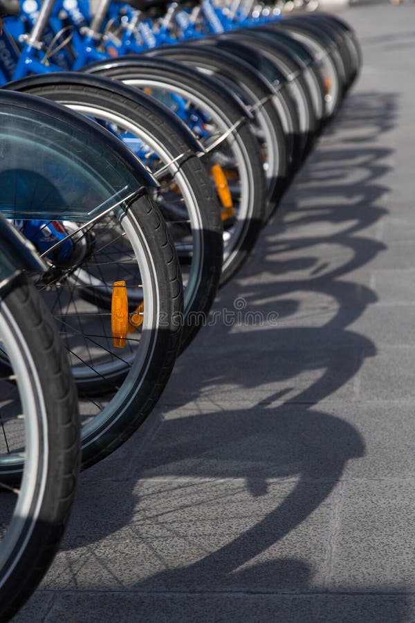 Line of blue bicycles stock photo. Image of shadow, pavement - 46265744