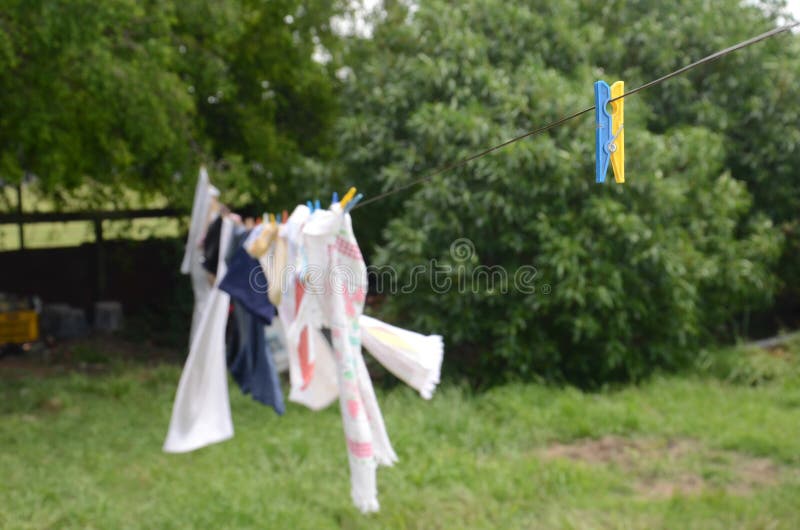 A Line of Clothes Hanging on a Clothesline Stock Photo - Image of hang ...
