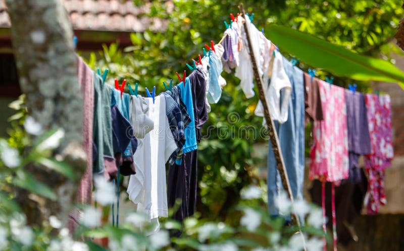 A Line of Clothes Hanging on a Clothesline in a Yard Stock Photo ...