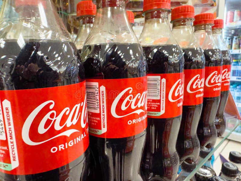 Line of Coca-cola Bottles with Red Caps in Store Setting Editorial ...