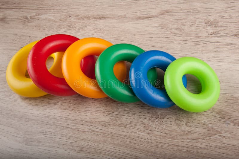 Line of Colored Toy Plastic Rings on Table Stock Image - Image of line ...