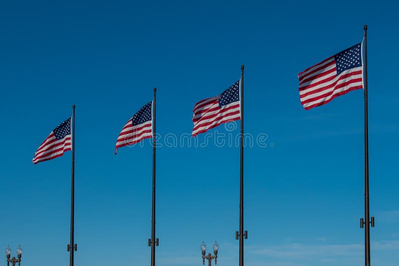 Line of Four American Flags Waving on Blue Sky Stock Photo - Image of ...