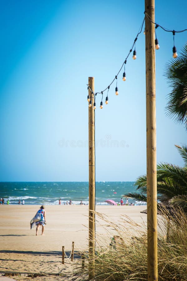 Line of Light Bulbs Lighting the Way To a Terrace on the Beach ...