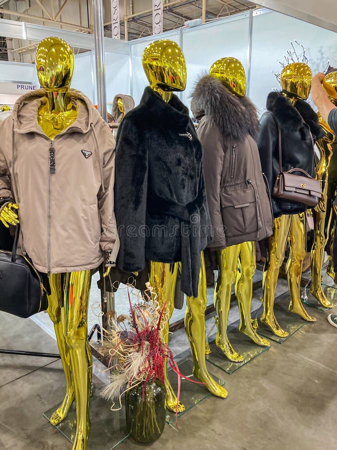 Line of Mannequins Display Various Outfits in a Neutral Setting, with ...